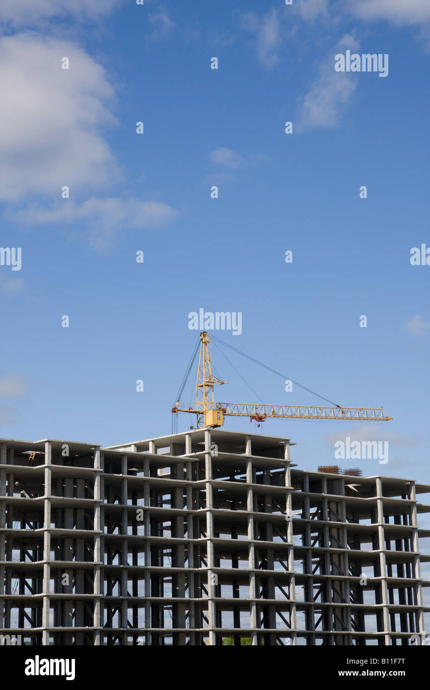 Exterior of uncompleted building and crane Stock Photo - Alamy