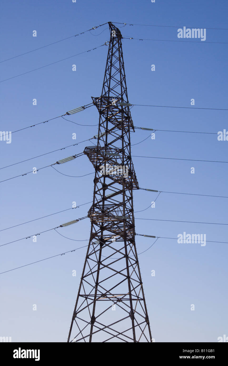 High voltage power line pillar against blue sky Stock Photo - Alamy