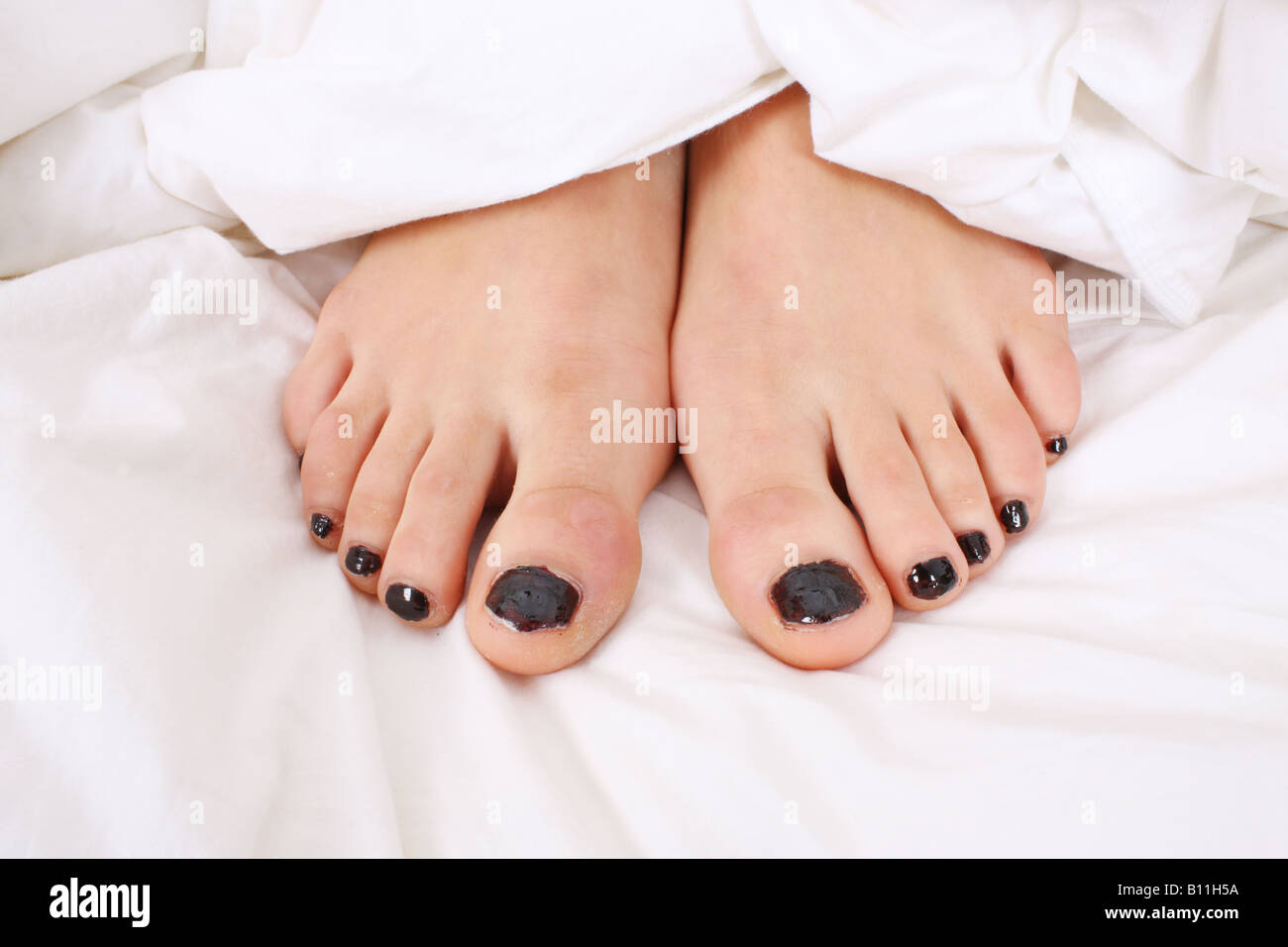 Womans Feet Under the Duvet Model Released Stock Photo - Alamy