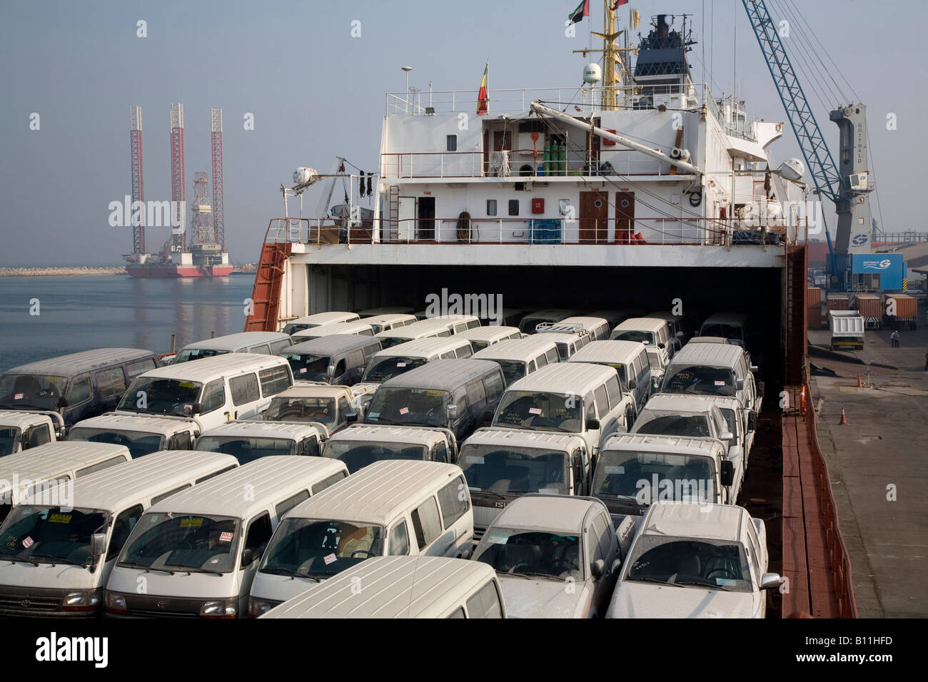 Trucks and lorries loaded on to a ship at Port Khalid United Arab ...
