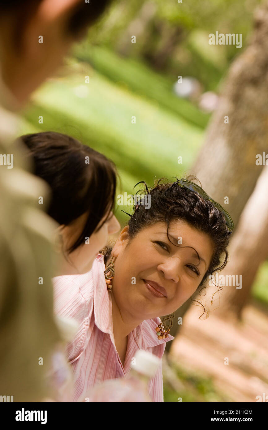 Woman looking past other woman Stock Photo - Alamy