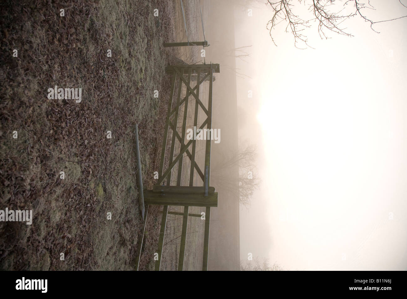 Gate and fence in mist Stock Photo - Alamy