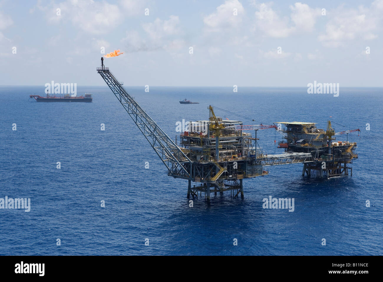 Oil production and exploration rigs connected by a bridge, in the South ...