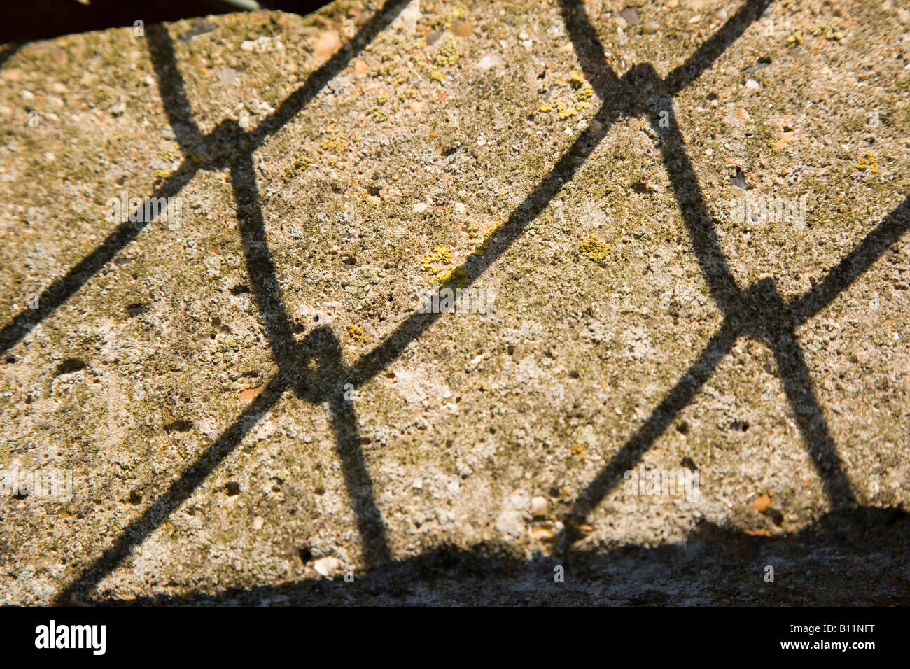 Shadow of chain-link fence Stock Photo - Alamy