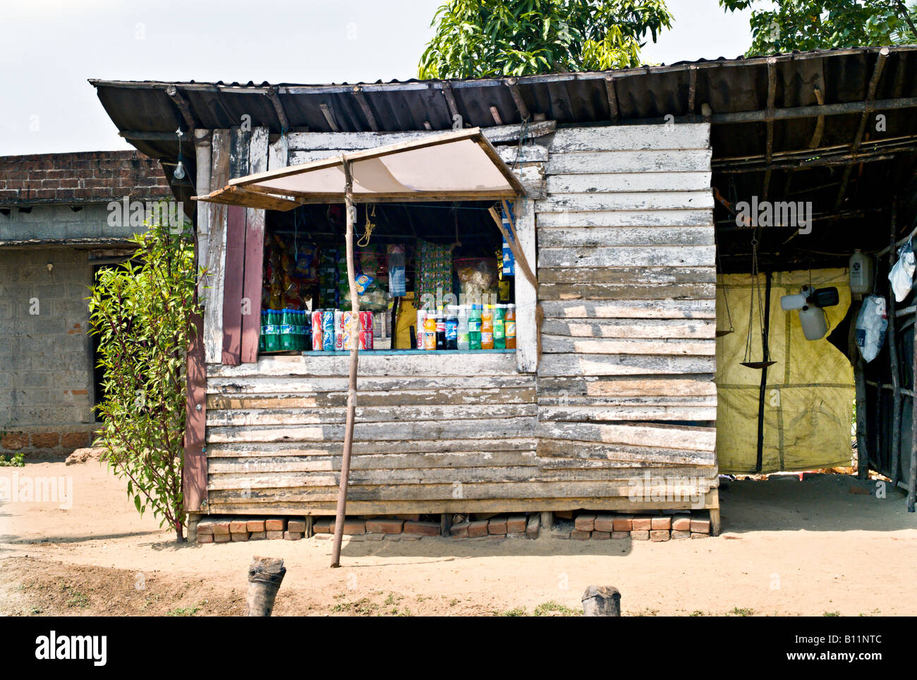 INDIA KERALA Tiny store selling snacks and drinks and an attached fish ...