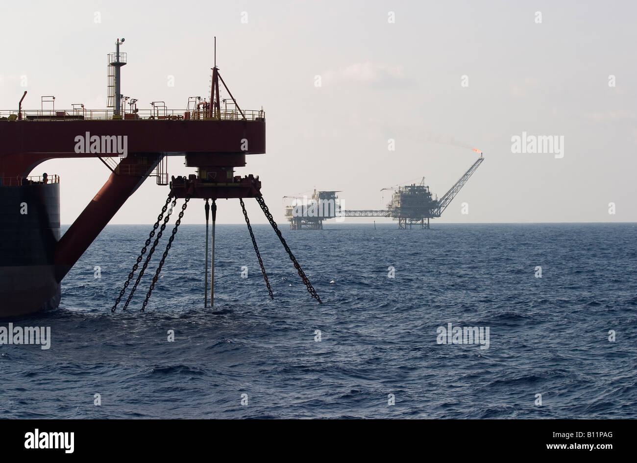FPSO in foreground with production and exploration rigs behind. Natuna ...