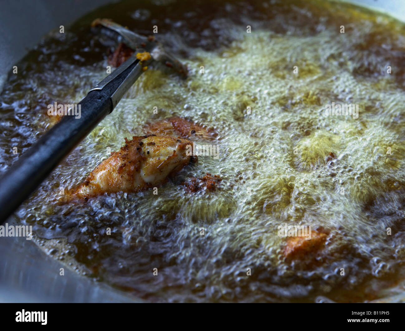 deep fried chicken in hot oil Stock Photo - Alamy