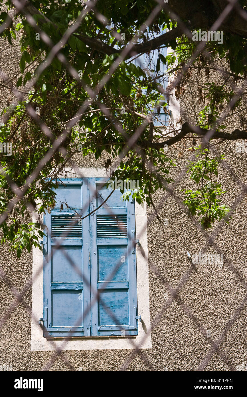 Wooden french shuttered windows behind a wire fence in Digne les Bains ...