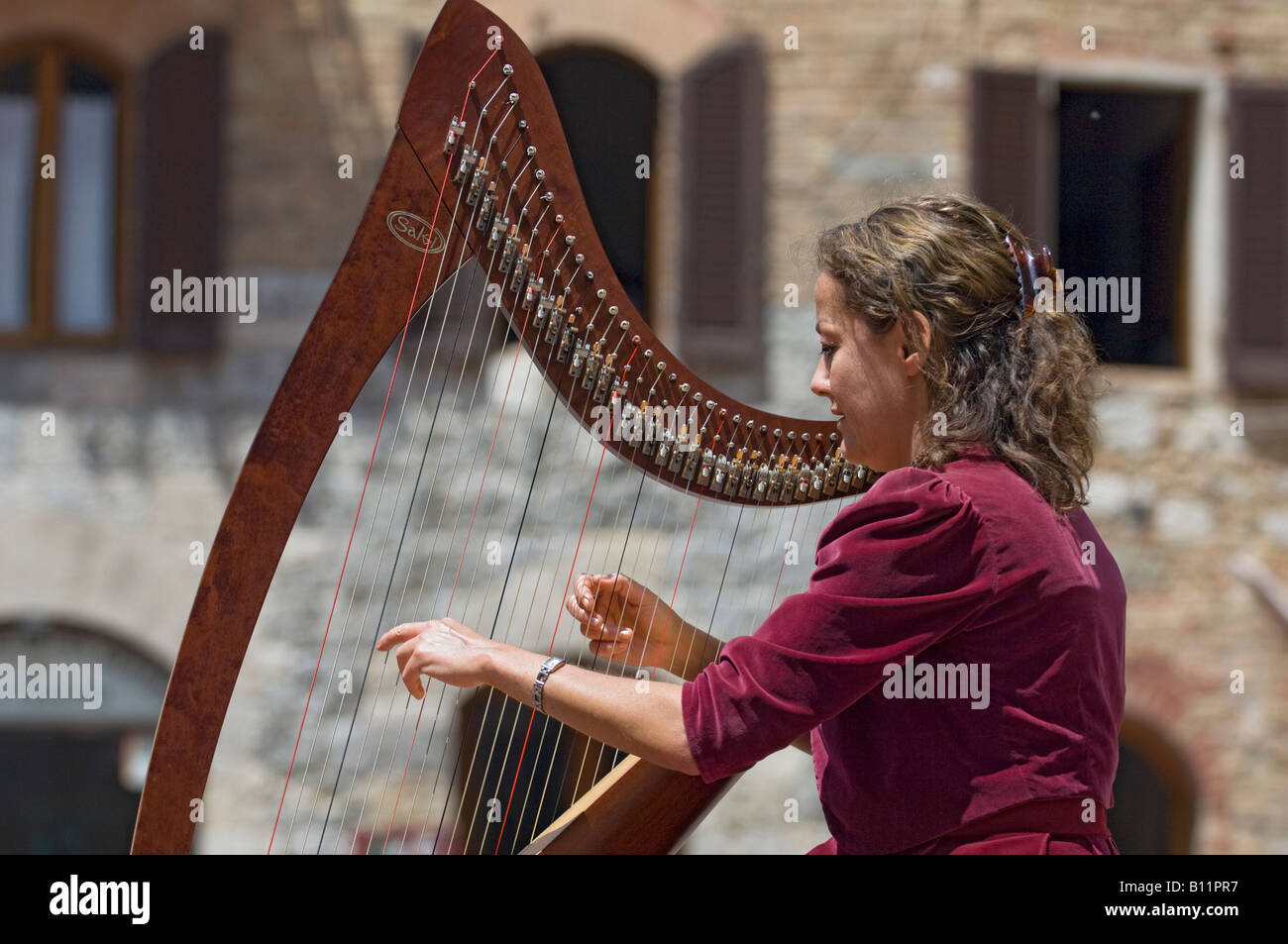 Harp Player in Piazza Del Duomo, San Gimignano, Tuscany, Italy Stock ...