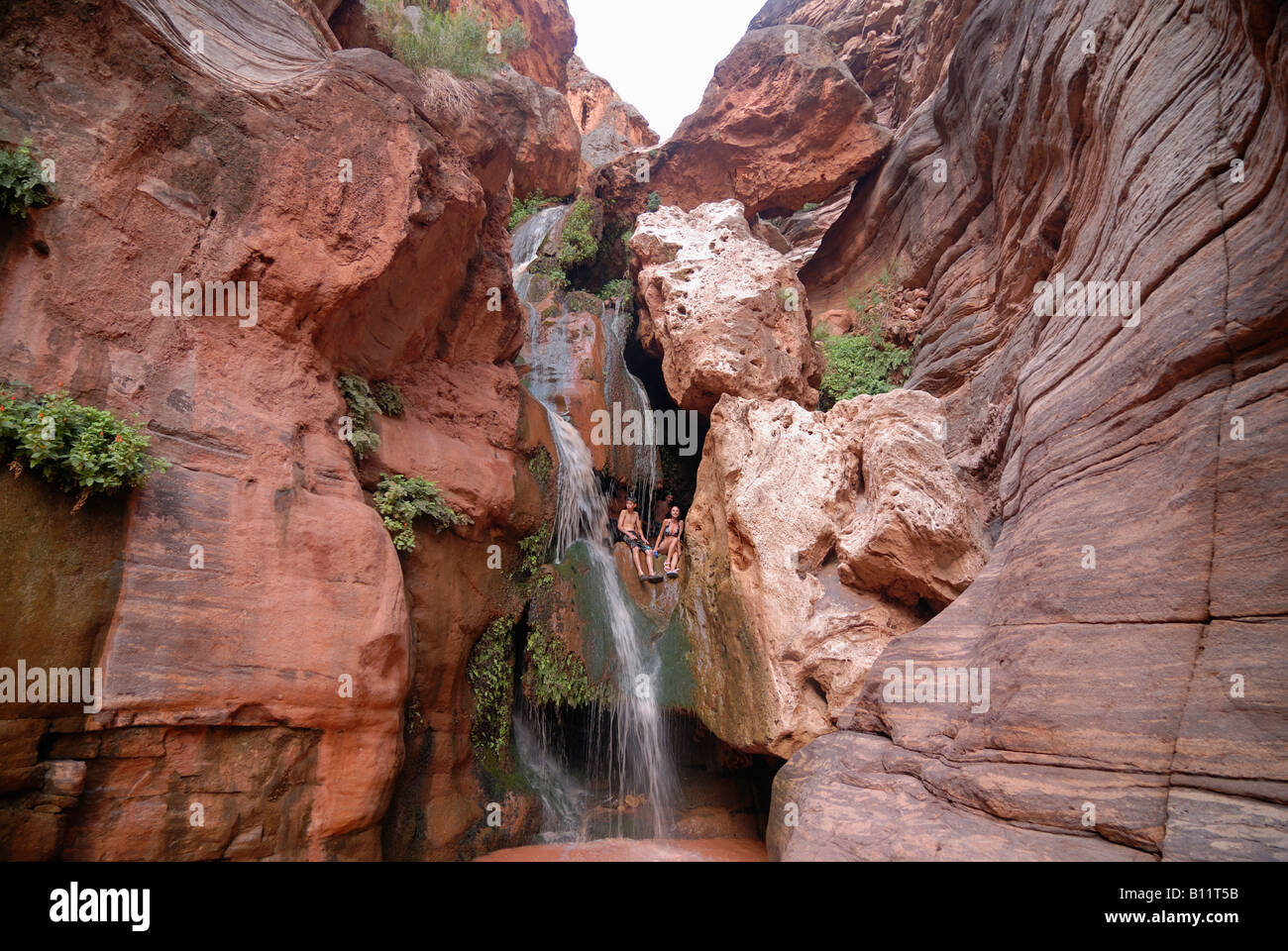 Tourist bathing in a waterfall Grand canyon seen while rafting down the ...