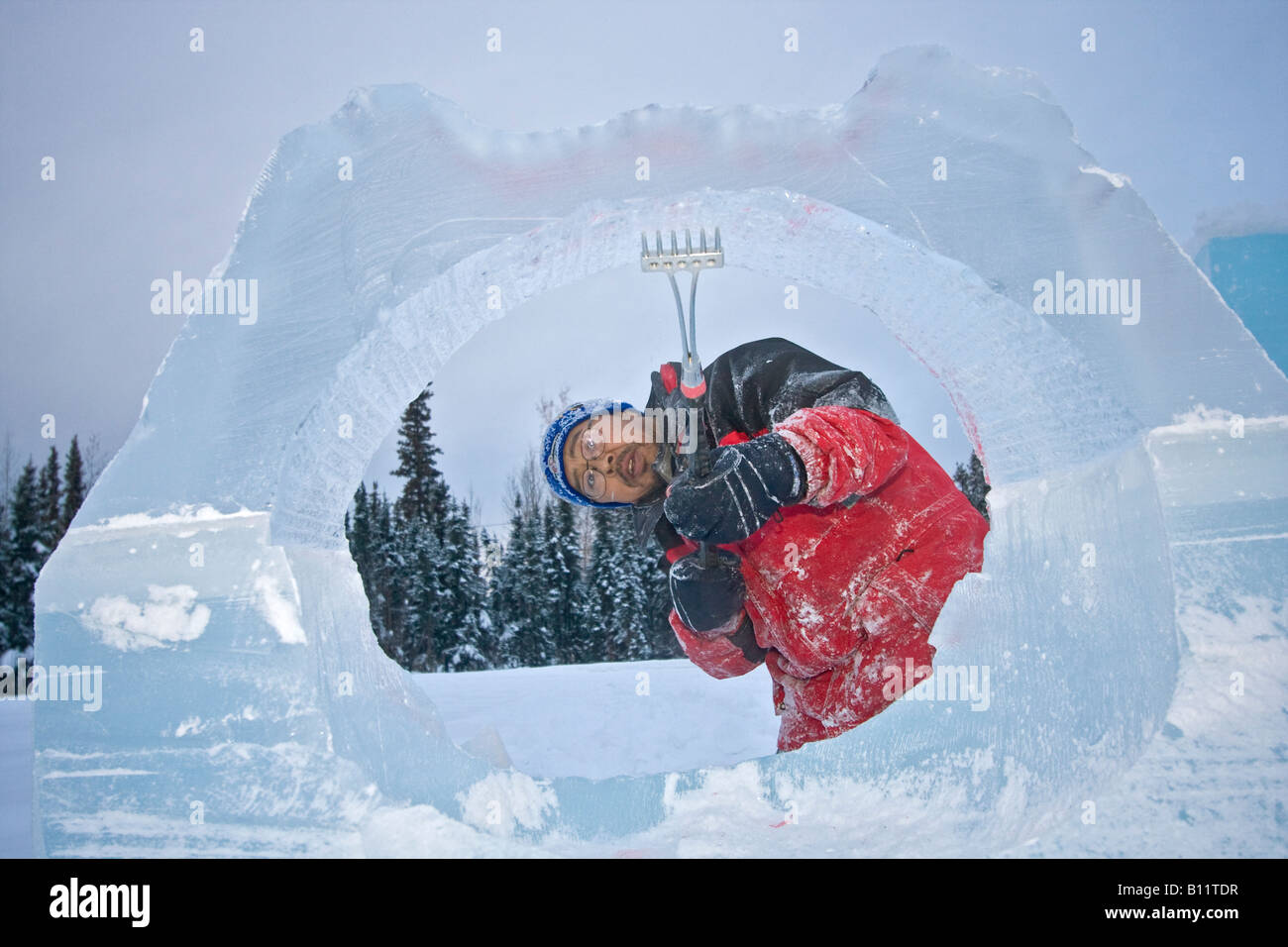 Ice sculptor Junichi Nakamora uses a rake to shape an ice sculpture for ...