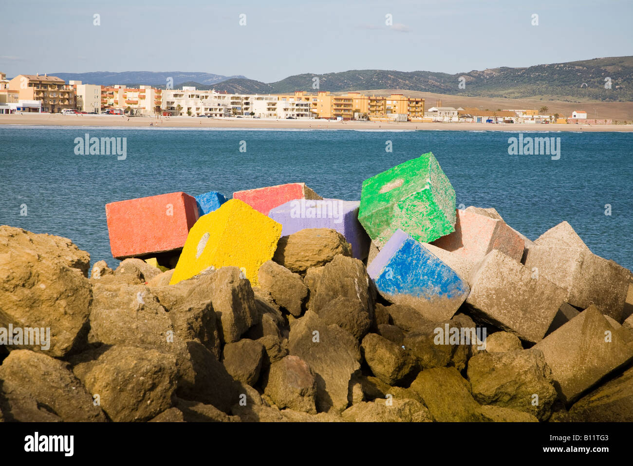 Coloured concrete cubes make up part of the breakwater in Barbate ...