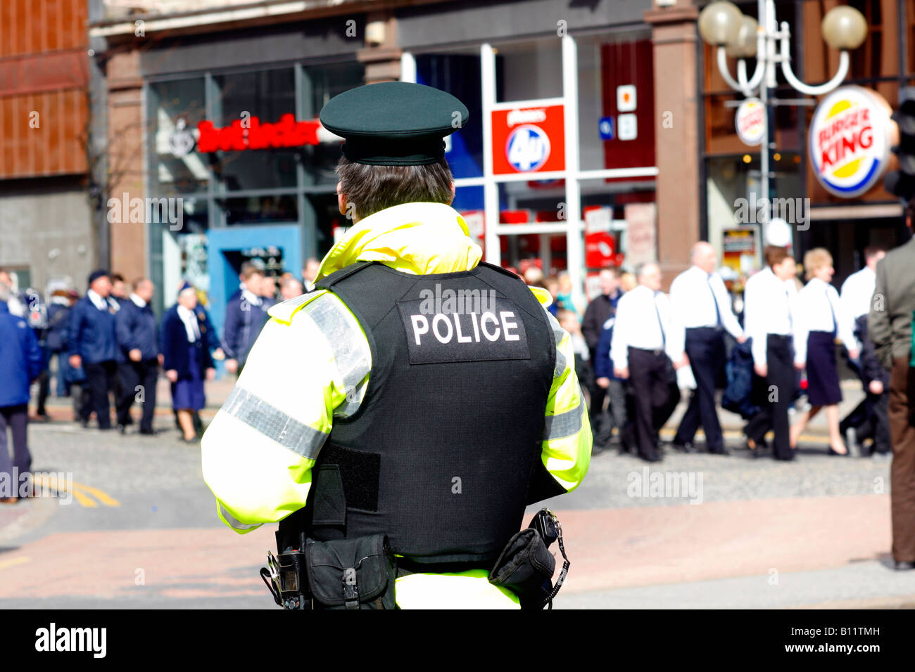 6th April 2008 Belfast policeman marshalling a boys brigade march Stock ...