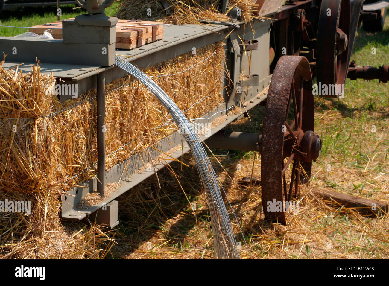 Straw baling with wire baler Stock Photo - Alamy