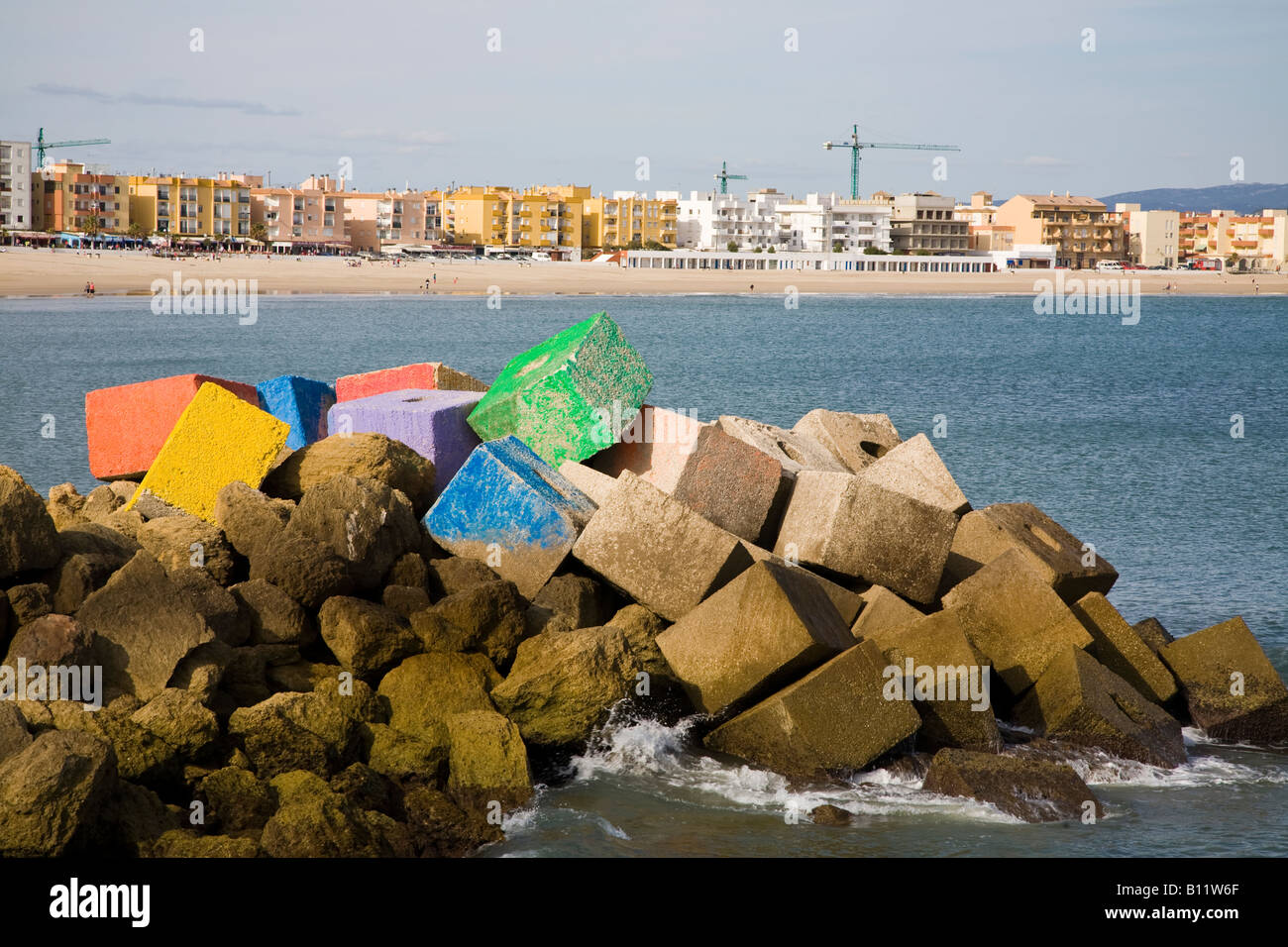 Coloured concrete cubes make up part of the breakwater in Barbate ...