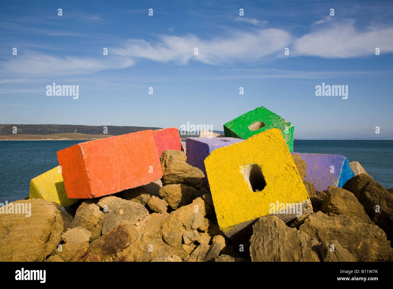 Coloured concrete cubes make up part of the breakwater in Barbate ...