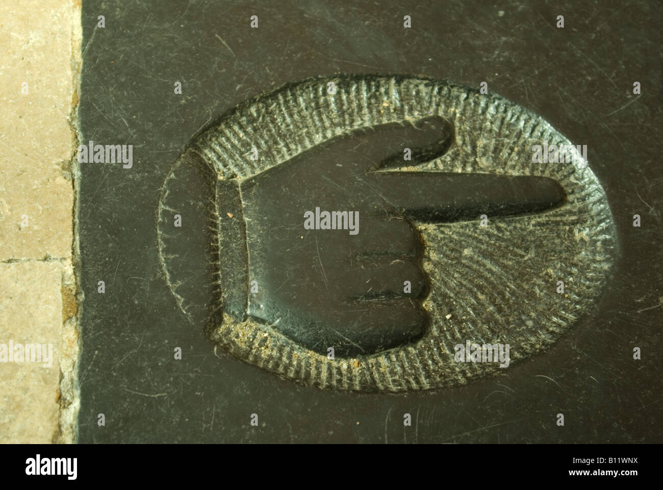 pointing finger carved in stone Stock Photo - Alamy