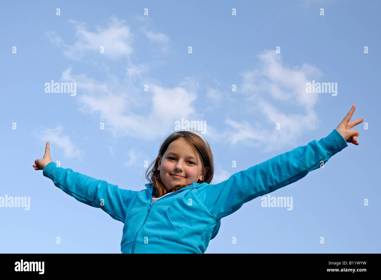 Joyful young girl spreading arms Stock Photo - Alamy