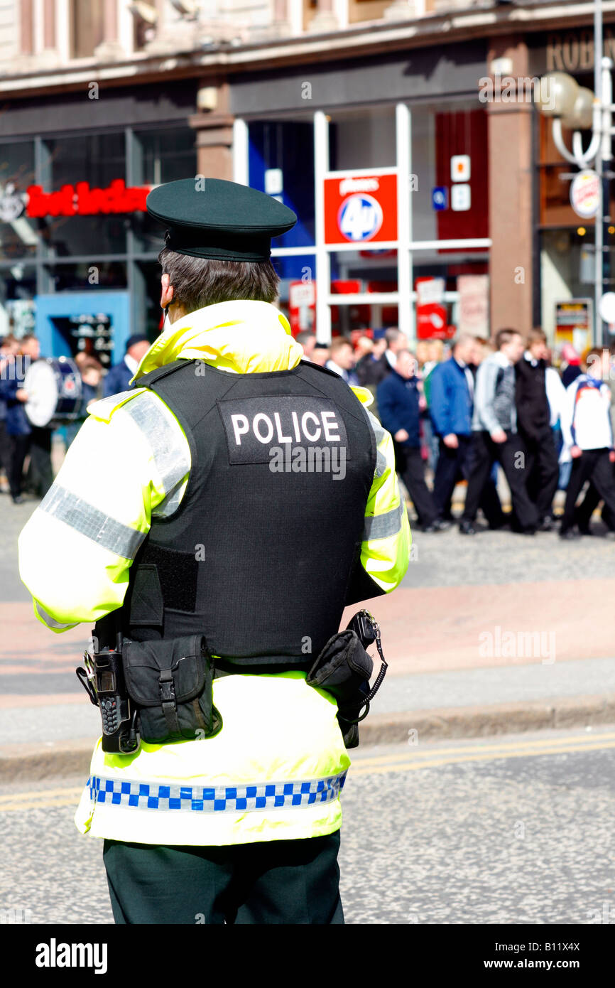 6th April 2008 Belfast policeman marshalling a boys brigade march Stock ...
