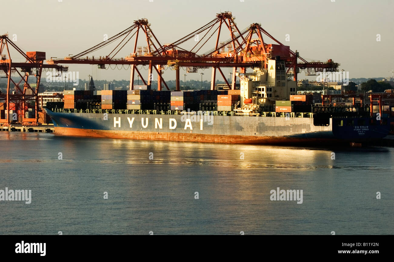 Large ocean freighter being loaded for a distant port Stock Photo - Alamy