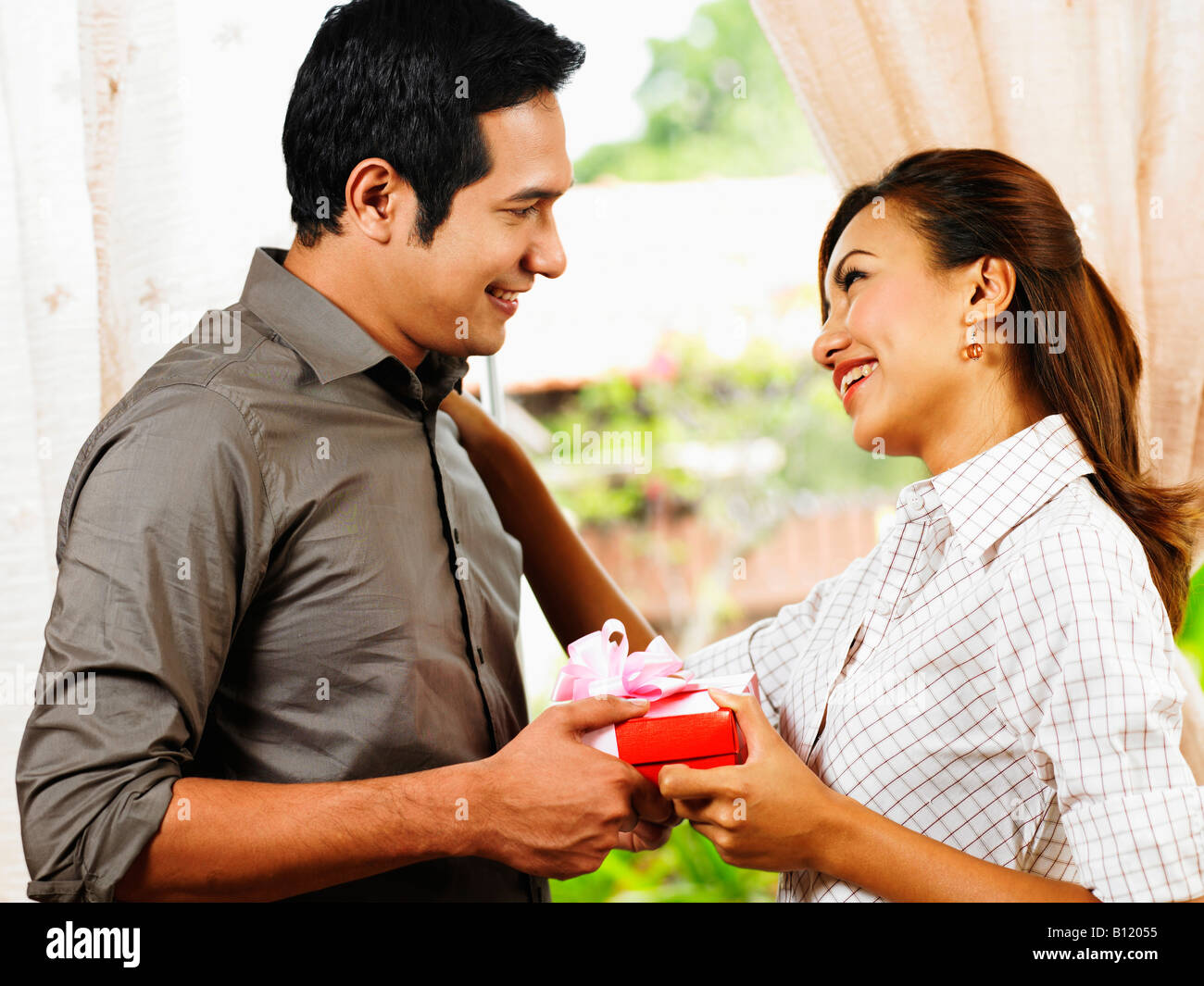 Exchanging holiday smiles hi-res stock photography and images - Alamy