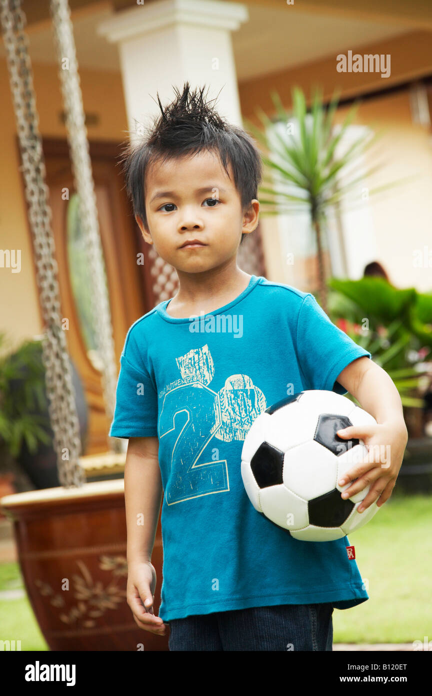 Standing in the lawn with ball in left hand Stock Photo - Alamy