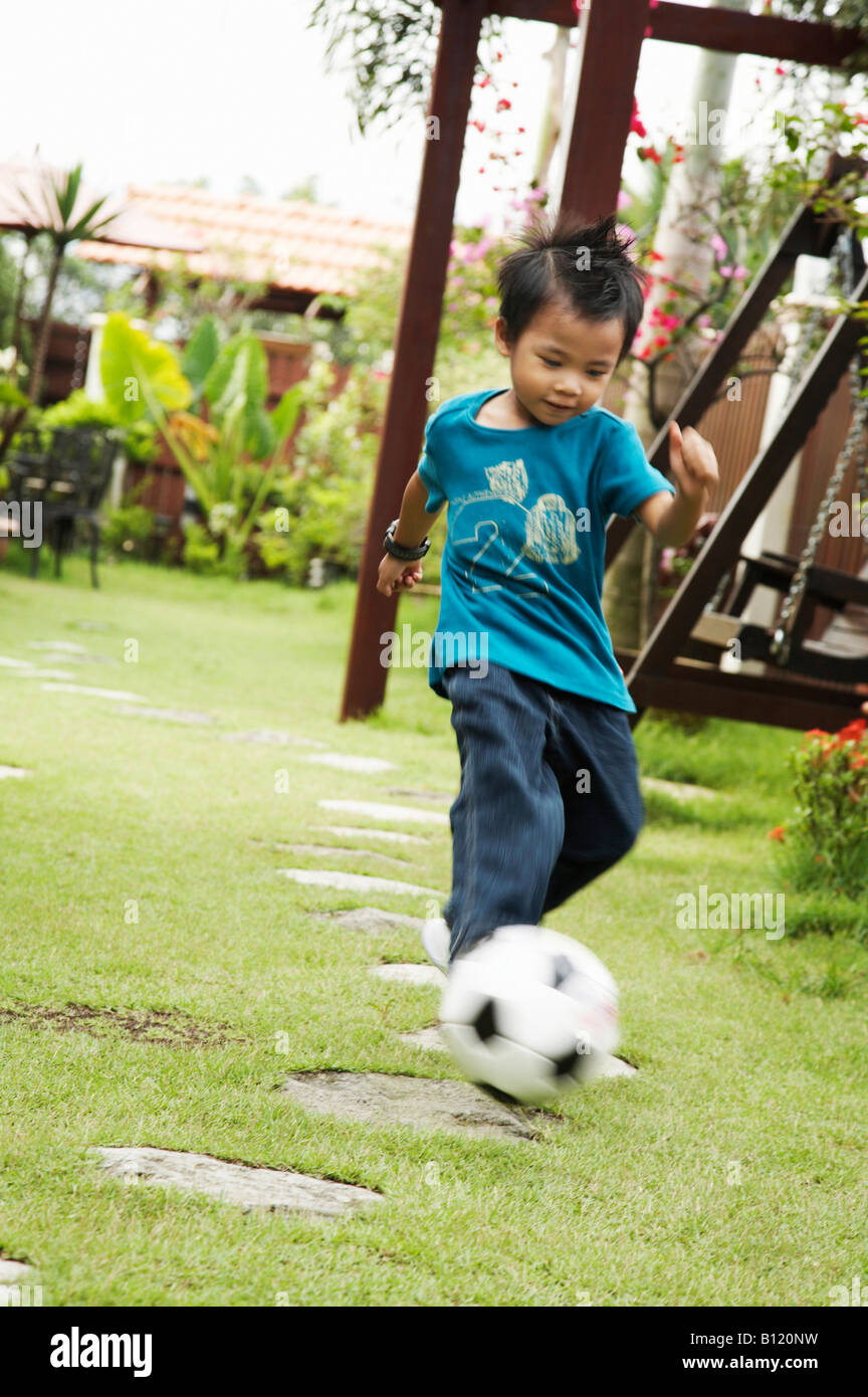 Young boy kicking the ball Stock Photo - Alamy