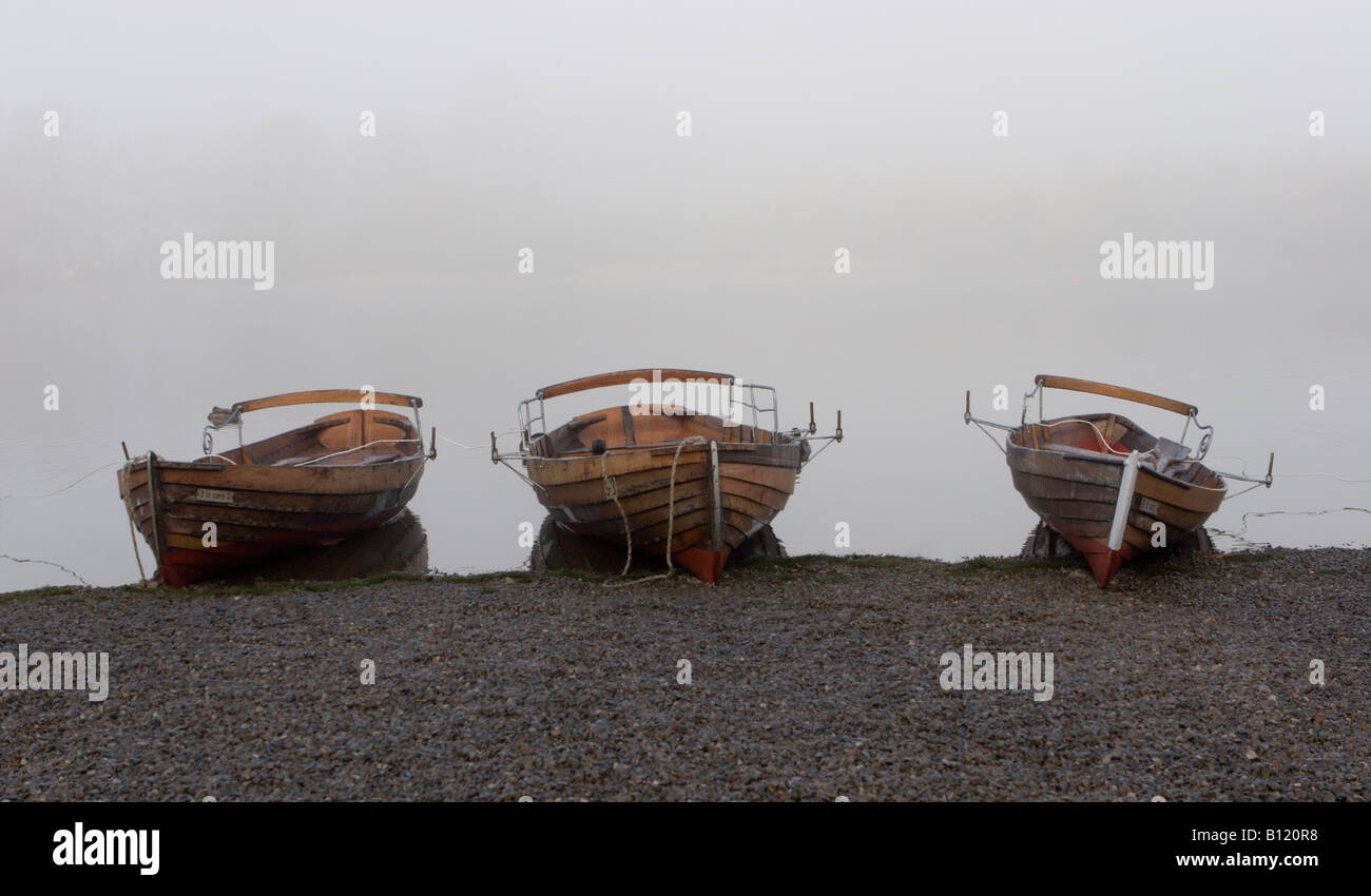 Three rowing boats on a misty morning at Keswick, Cumbria, England, UK ...