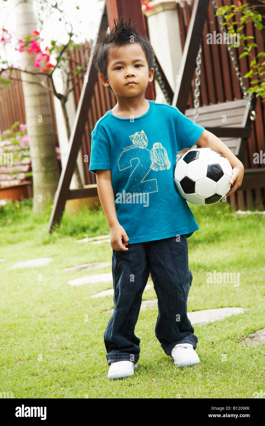 Boy holding ball in one hand Stock Photo - Alamy