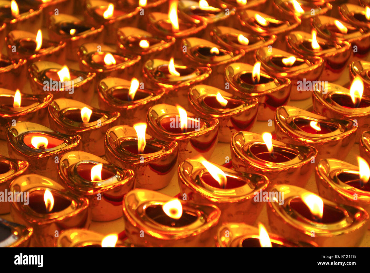 Illuminated gold ingot candles Stock Photo - Alamy