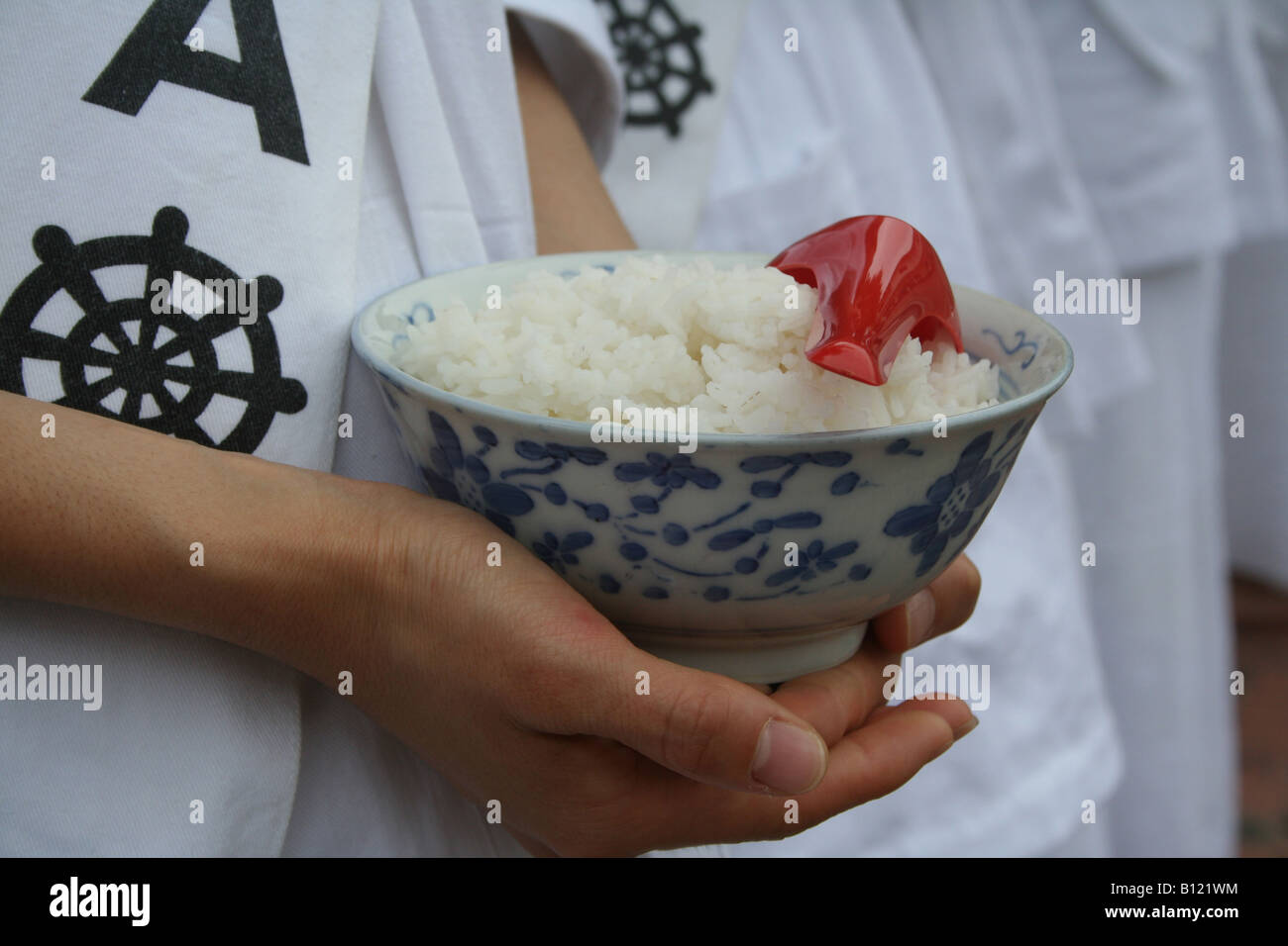 Hands holding bowl of rice for offering Stock Photo - Alamy