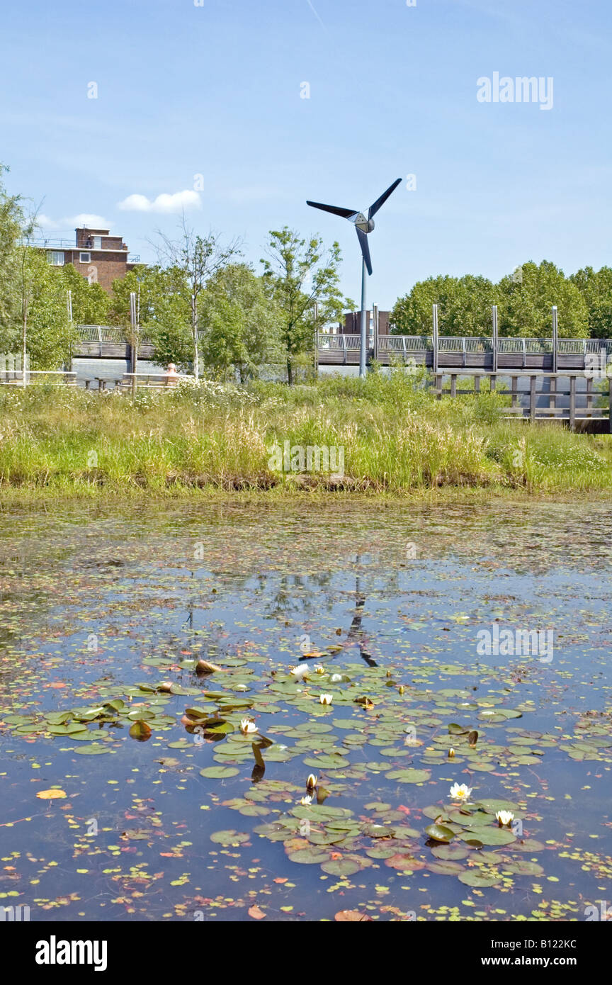 Wind turbine overlooking water lily pond Mile End Park London England ...