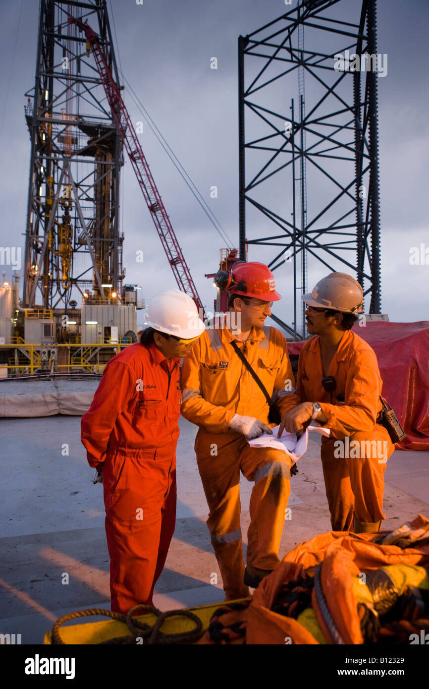 Oil workers discussing the work. Ensco rig. Natuna Field. Sea South ...
