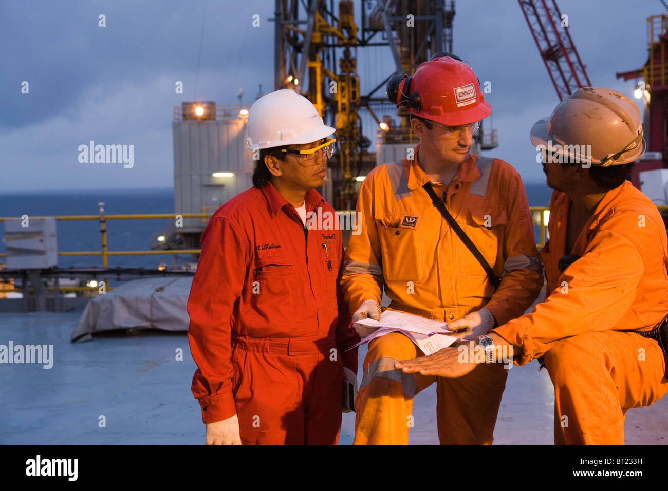 Oil workers discussing the work. Ensco rig. Natuna Field. Sea South ...