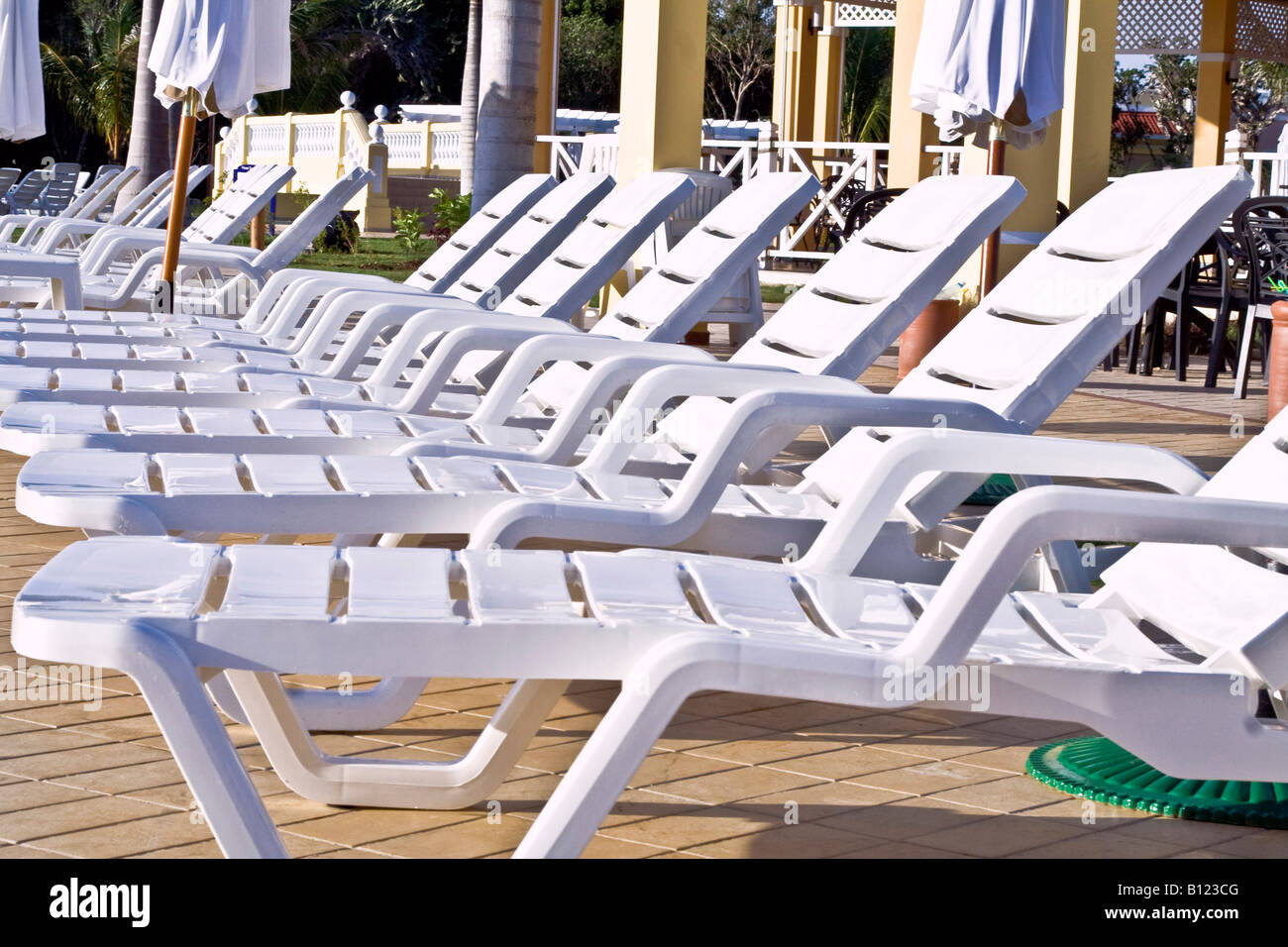 Caribbean holidays pool chairs Stock Photo - Alamy