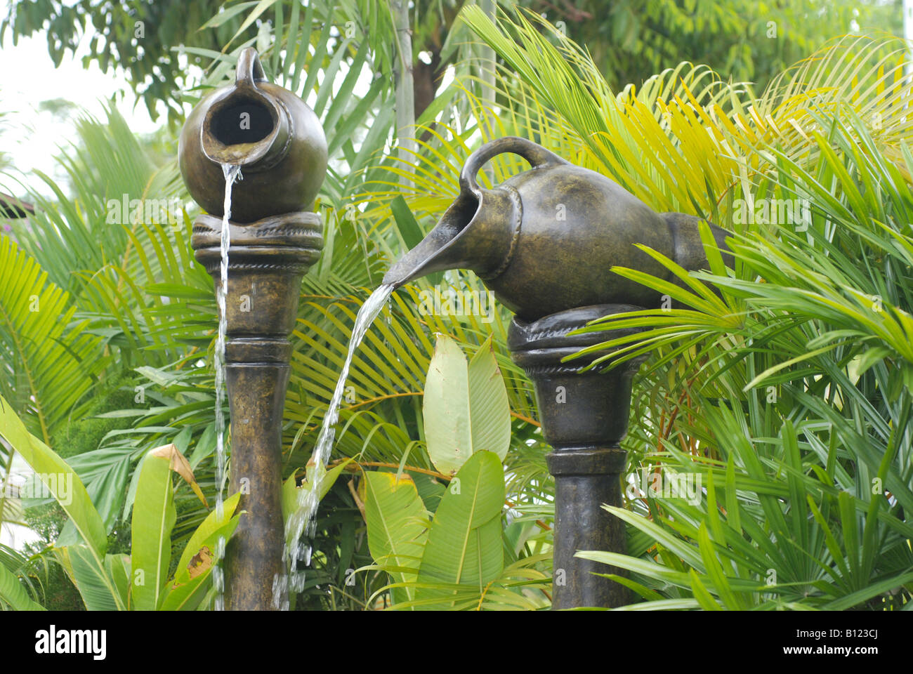 Water Flowing From Pitchers Stock Photo - Alamy