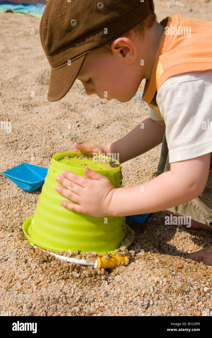 small boy making a sandcastle Stock Photo - Alamy