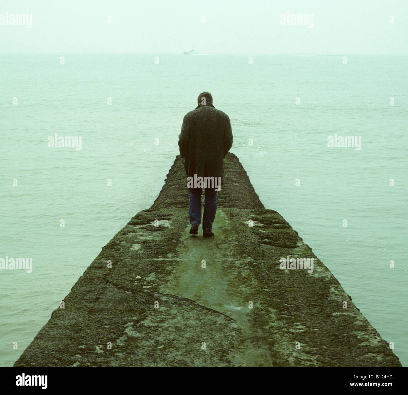 depressed male on pier Stock Photo - Alamy