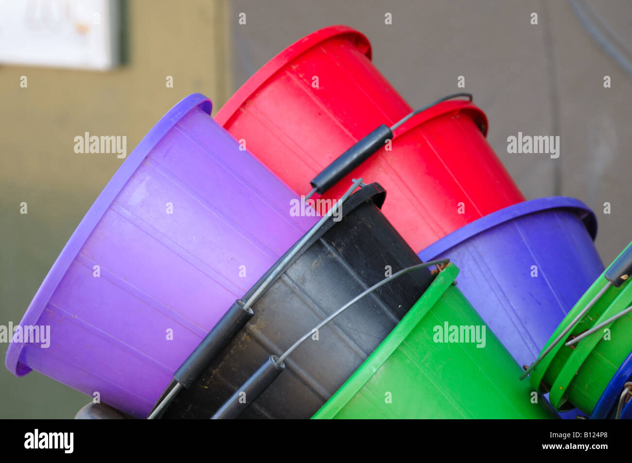 Coloured nimal feeding buckets at zoo Stock Photo - Alamy