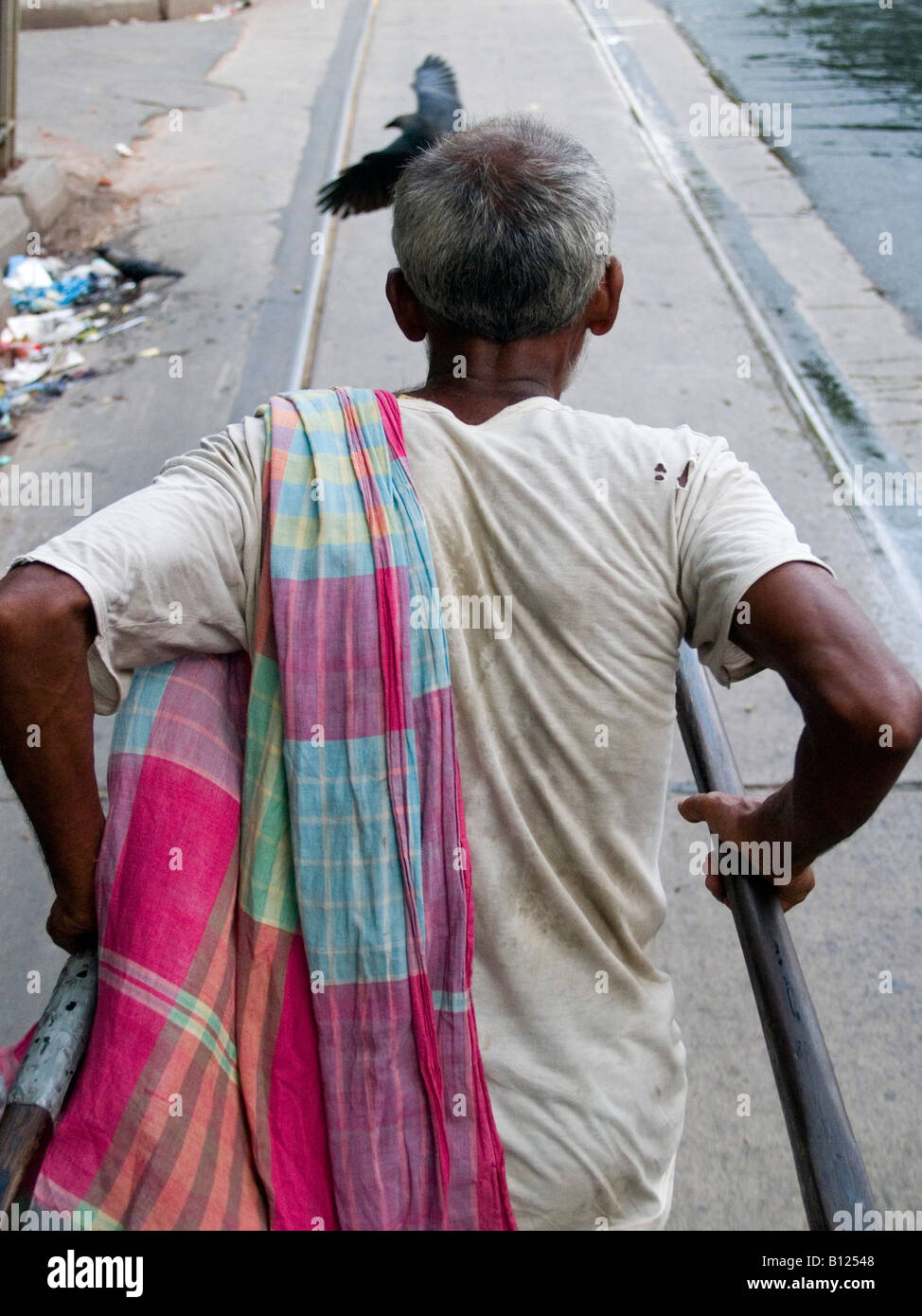 human rickshaw pulling his load through the streets of Calcutta India ...