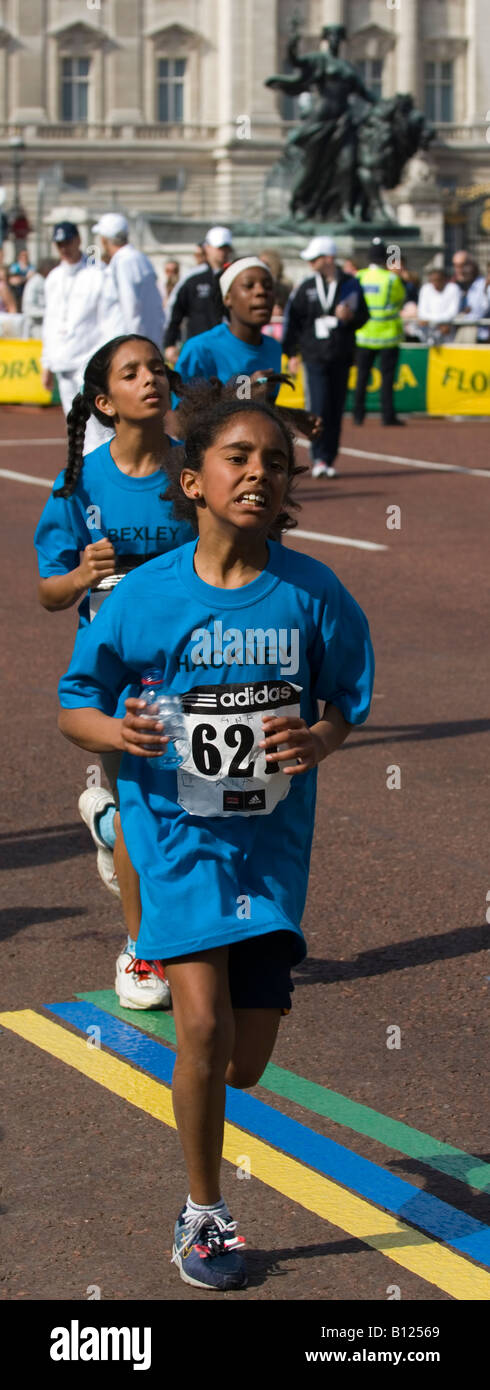 Young girl runners entering the last 200 metres, at the London Marathon ...
