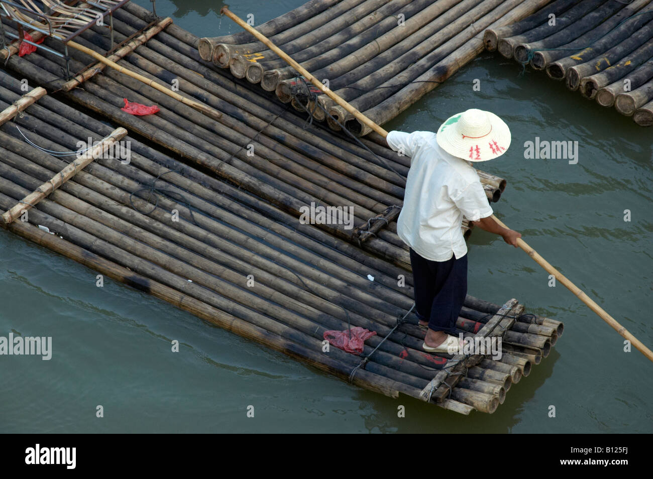 Man standing on a bamboo raft, Li River, Yangshuo/Guilin, China Stock ...