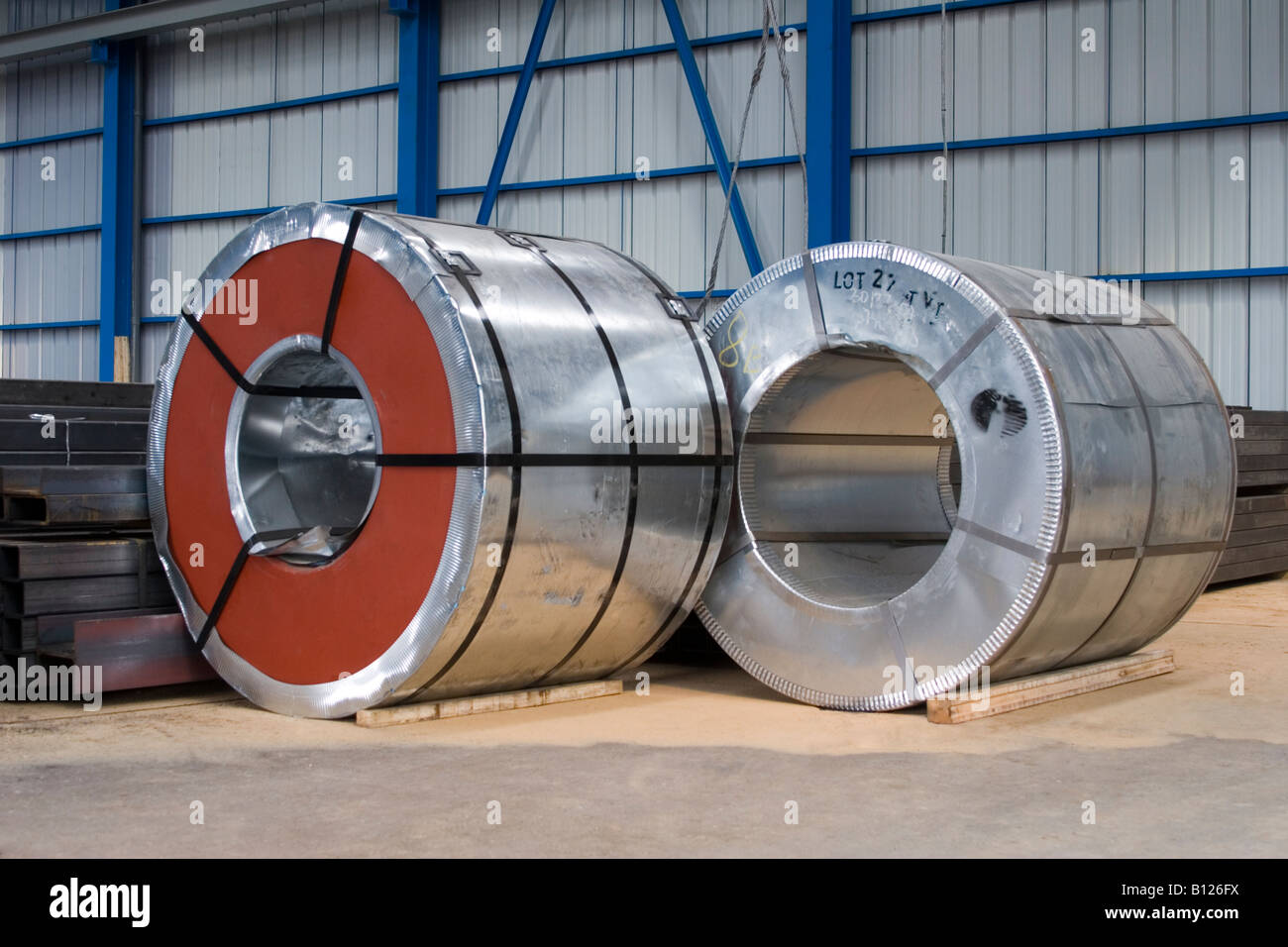 Two electrical cable coil cylinders packaged in industrial warehouse ...