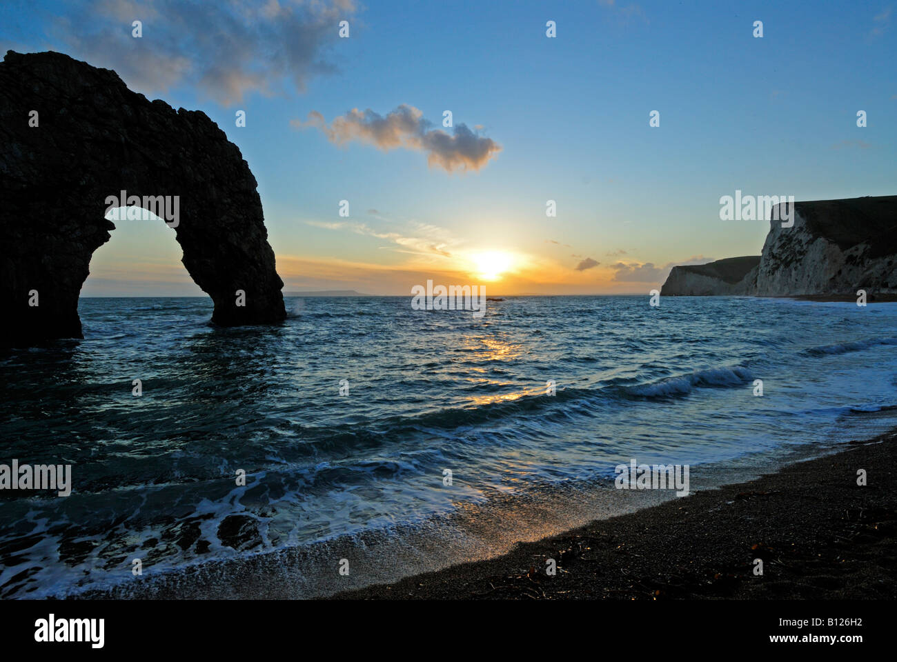Durdle Door natural limestone arch at sunset Stock Photo - Alamy