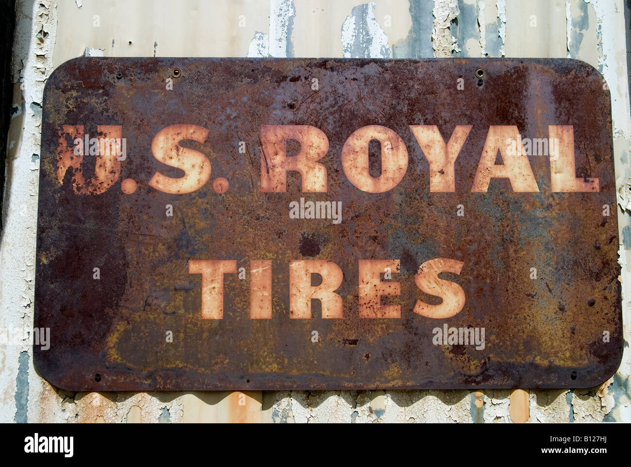 Old weathered and rusty metal sign advertising U.S. Royal Tires Stock ...