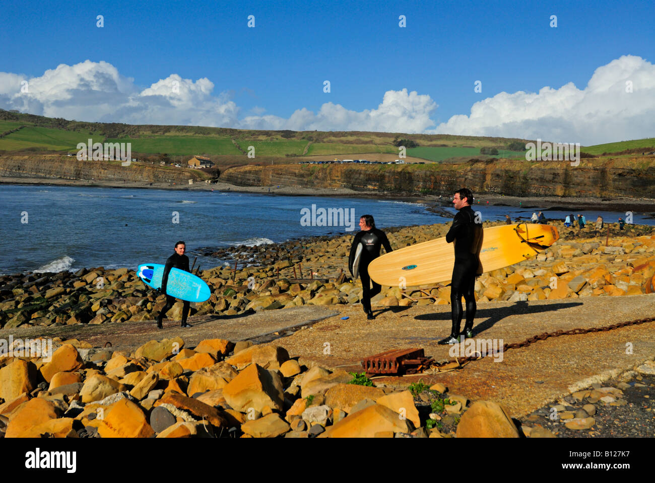 Surfers near Kimmeridge Jurassic Coast World Heritage site Dorset ...