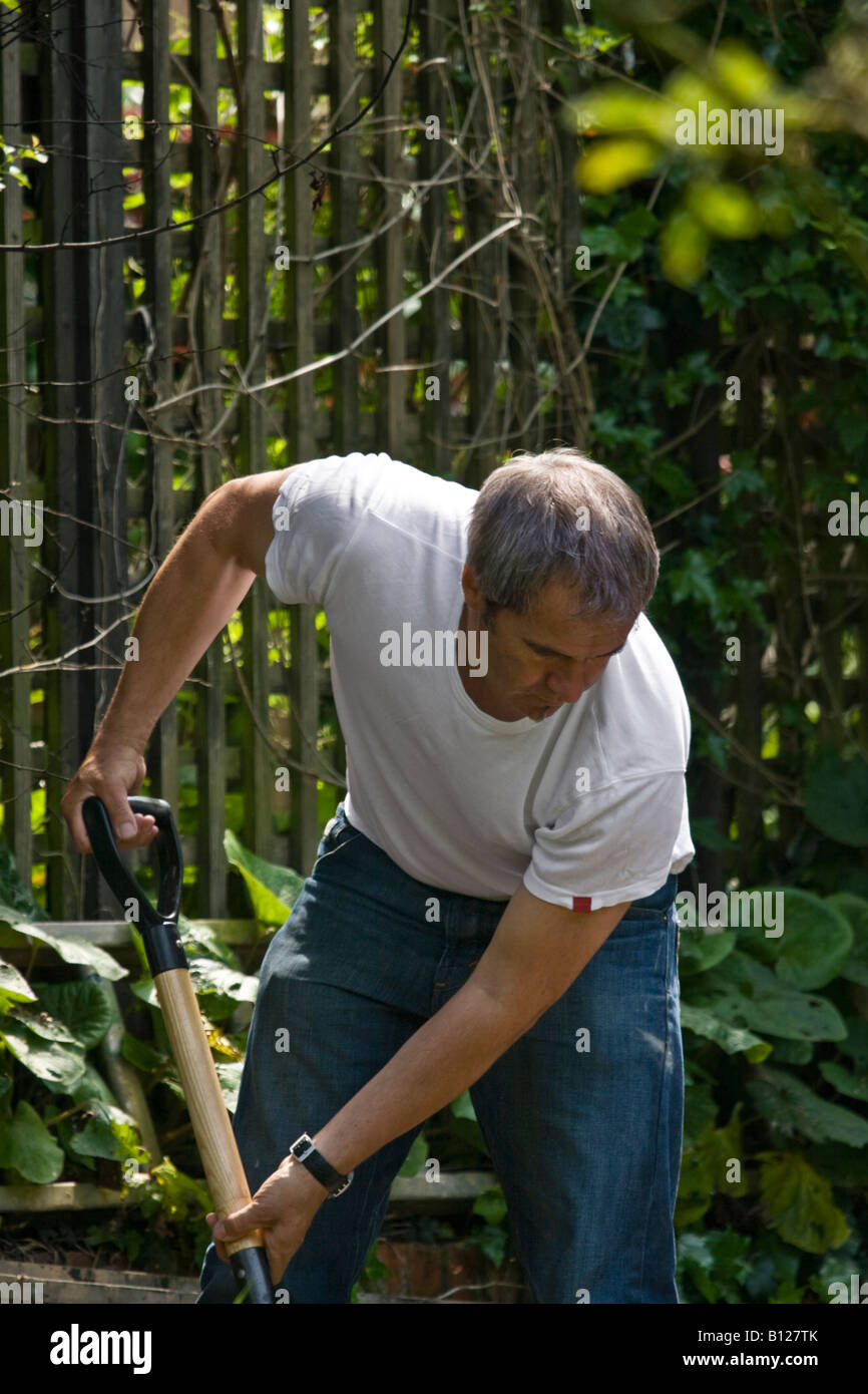 Man digging the garden Stock Photo - Alamy