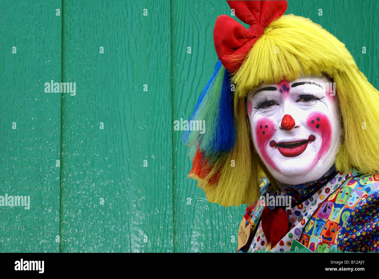 Professional American circus clown isolated against green background ...
