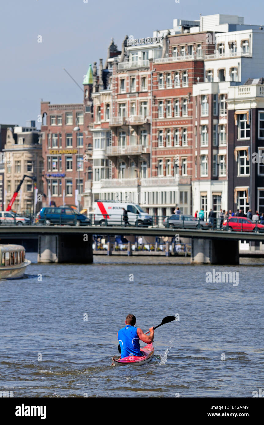 Kayaker paddling through Amsterdam Amsterdam Holland The Netherlands ...