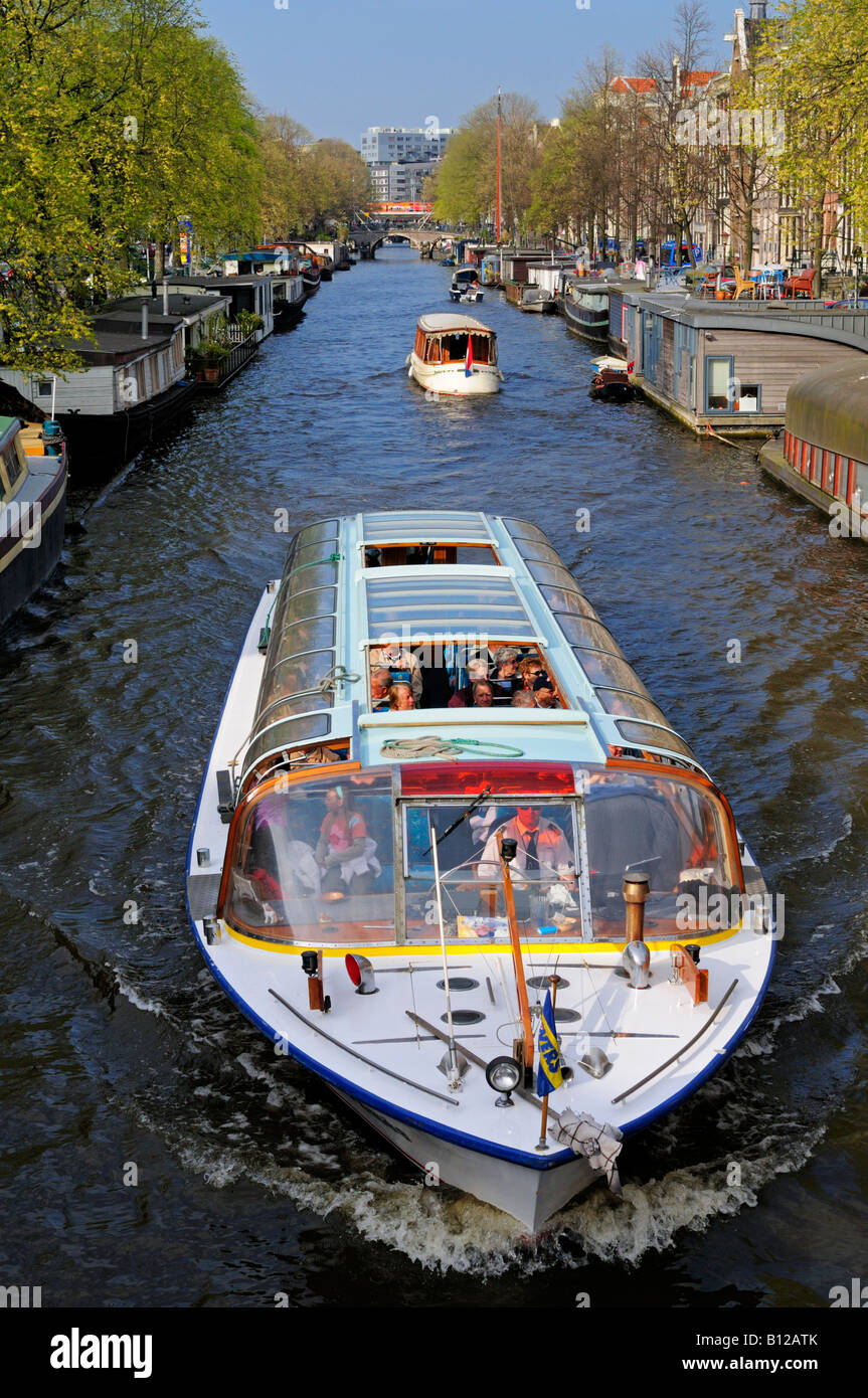 A tour boat on a canal Amsterdam Holland The Netherlands Europe Stock ...